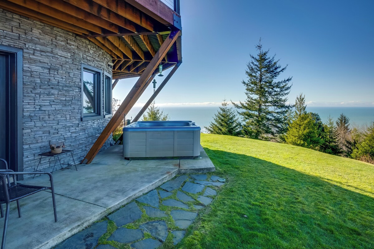 Uma casa moderna com fachada de pedra, uma banheira de hidromassagem e vista para o oceano.