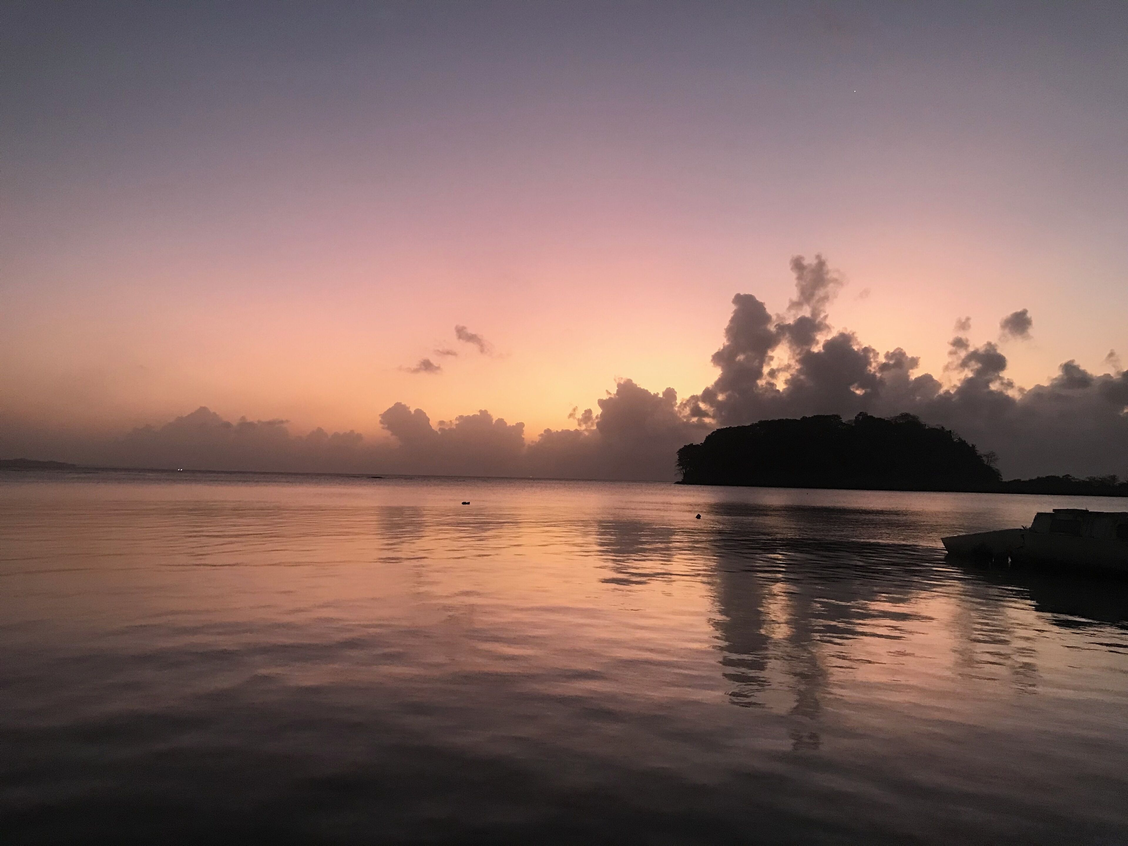 Água calma refletindo o céu ao pôr do sol.