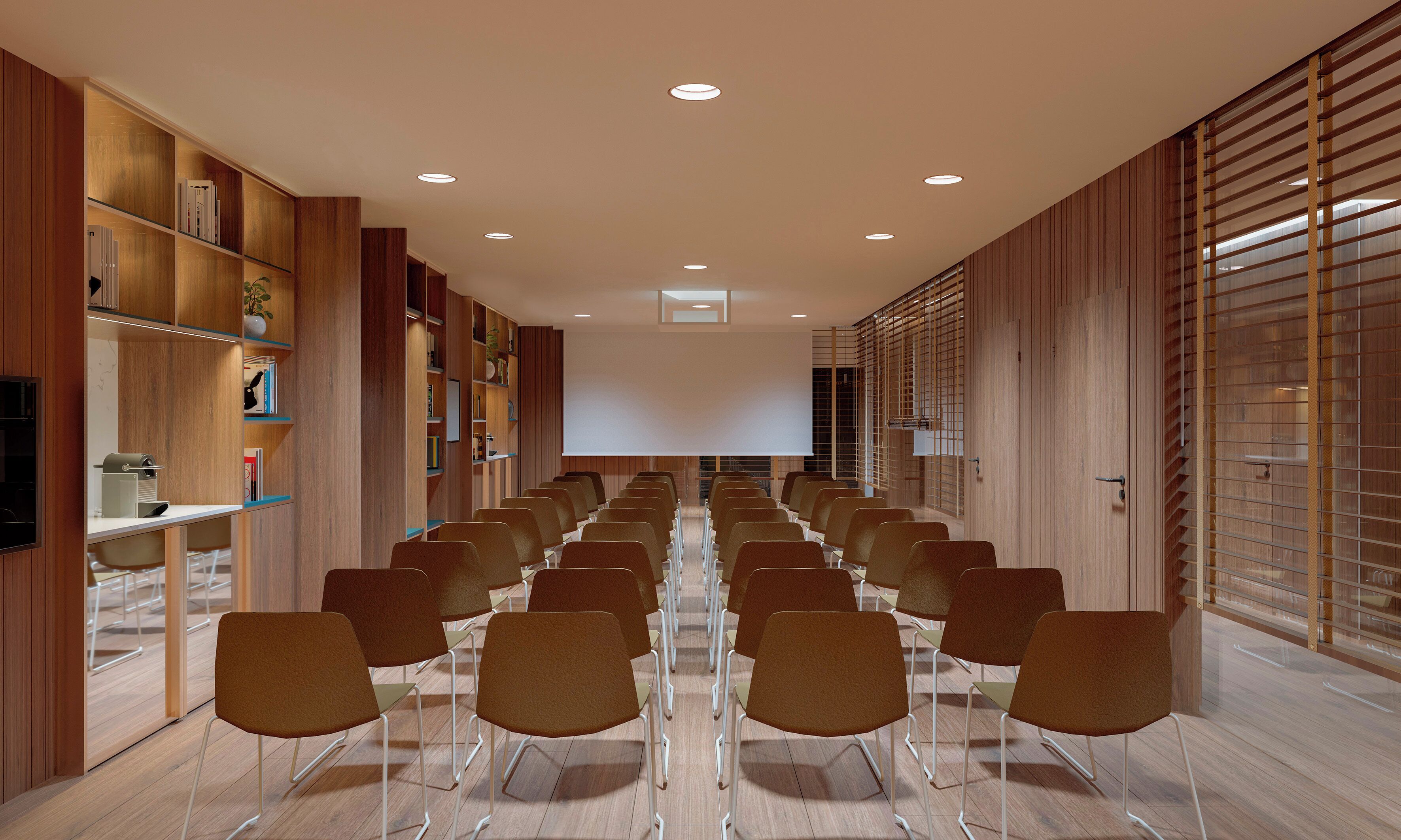 Uma sala de conferências com fileiras de cadeiras voltadas para uma tela central, painéis de madeira nas paredes e luminárias embutidas no teto.