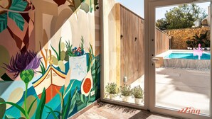 Quarto com uma grande janela para uma piscina e jardim.