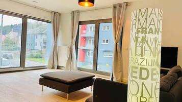 Apartamento luxo | Área de estar | TV de tela plana