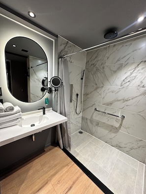 Quarto superior, 1 cama King (Accessible) | Banheiro | Chuveiro, chuveiro com efeito de chuva, produtos de toalete grátis