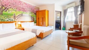 Quarto de hotel com duas camas, um guarda-roupa de madeira, uma televisão e vista para uma cerejeira através da janela.