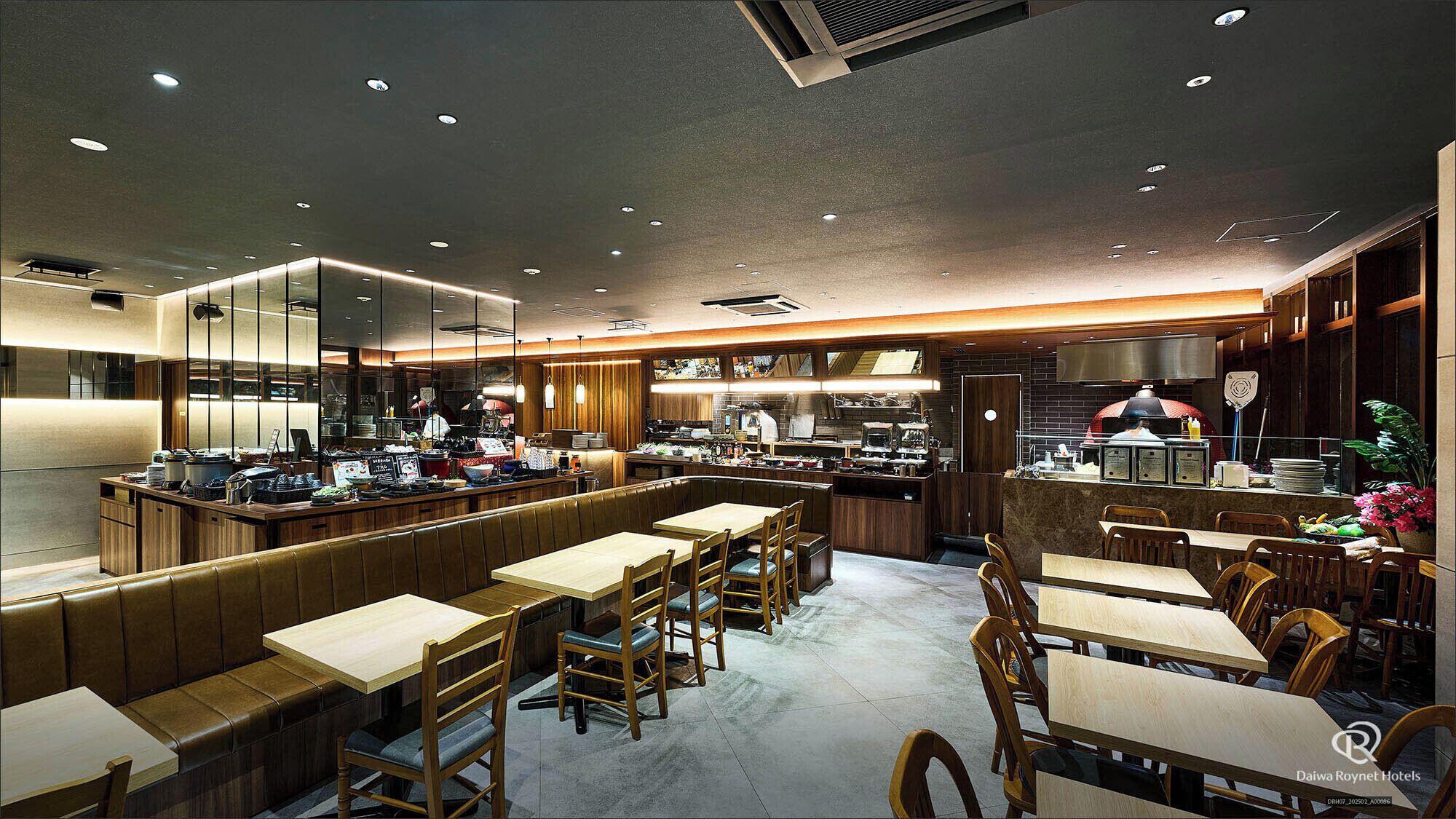 Um restaurante moderno com cabines e mesas de madeira, uma área de cozinha e um bar.