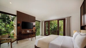 Quarto de hotel moderno com uma cama grande, uma mesa de escritório e uma televisão.