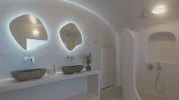 Uma casa de banho moderna com um design curvo único, uma bacia grande e uma área de duche separada.