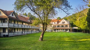 Um edifício grande com várias varandas e um jardim bem cuidado.