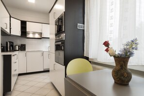 Apartamento Deluxe | Cozinha privada | Um frigorífico, um forno, uma máquina de lavar louça 