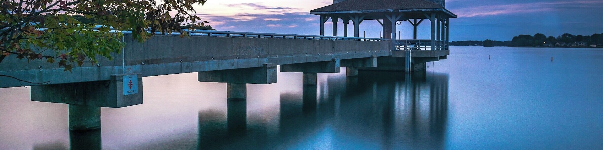 beautiful park with a nice view of the lake during sunset hour.