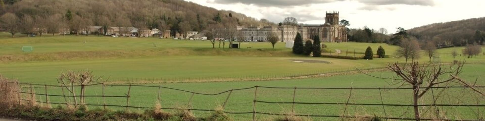 Hilton to Milton Abbas: Road The road passes through farm land and alongside Milton Abbey School seen in the distance.