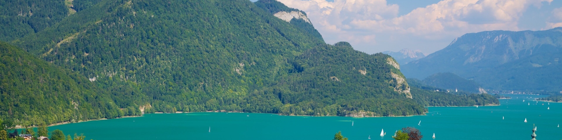 St. Gilgen which includes a lake or waterhole, mountains and a small town or village