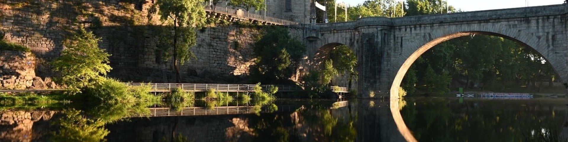 Fun shot at sunrise of Church São Gonçalo and Ponte de São Gonçalo bridge reflecting in Tamega River