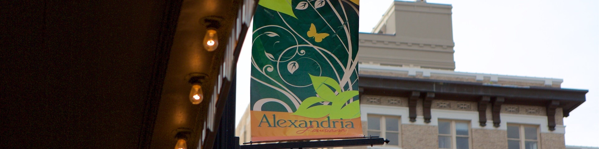 A building with a sign that reads "Alexandria" and a decorative banner with a leaf and butterfly design.