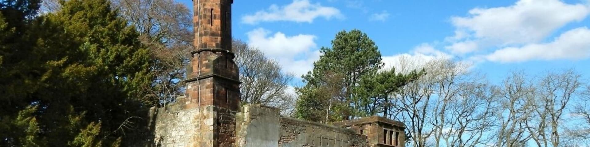Rosshall Gardens: the old boiler house. This building was Rosshill, a house. In its role as the main house of the estate, it was superseded by Ross Hall (built in 1877). At some later time, the original building, Rosshill, was made a boiler house; the incongruous castellated chimney is a reminder of that use.