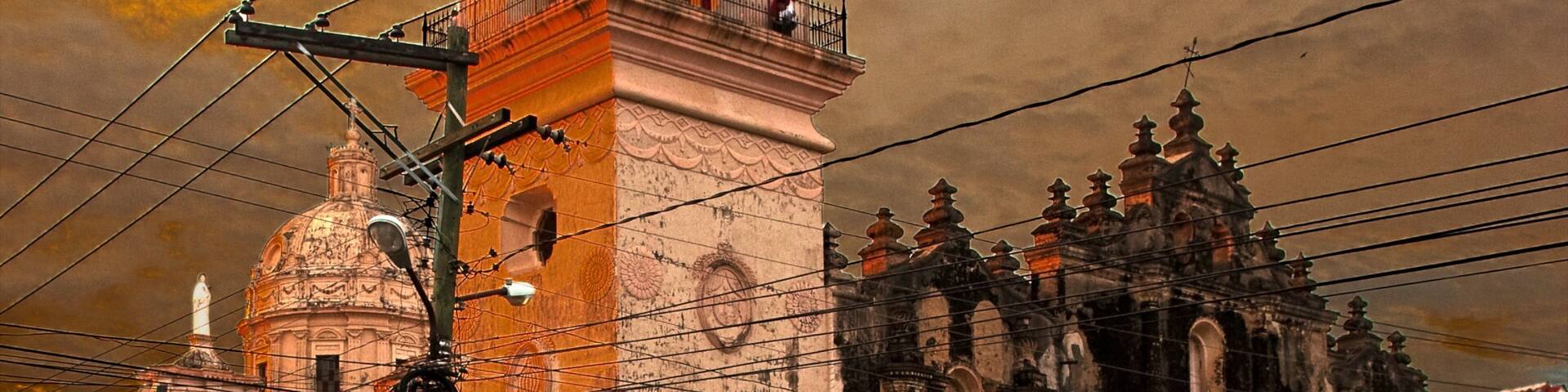 Nicaragua showing a sunset, religious elements and heritage architecture