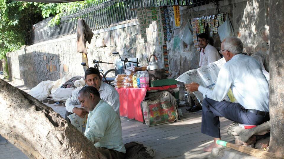 People seem to live out their lives in the streets of New Delhi. Here they gather to read the newspapers.