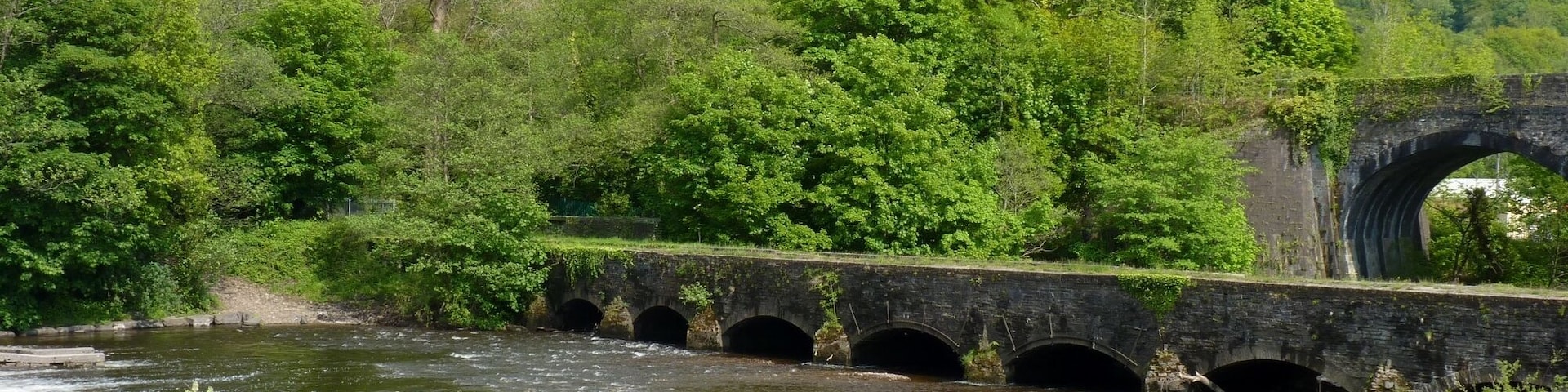 Tennant Canal, shortly after it branches from the Neath Canal, crosses over to the west bank of the river Neath at Aberdulais. It is a scheduled monument in Neath Port Talbot, South Wales
