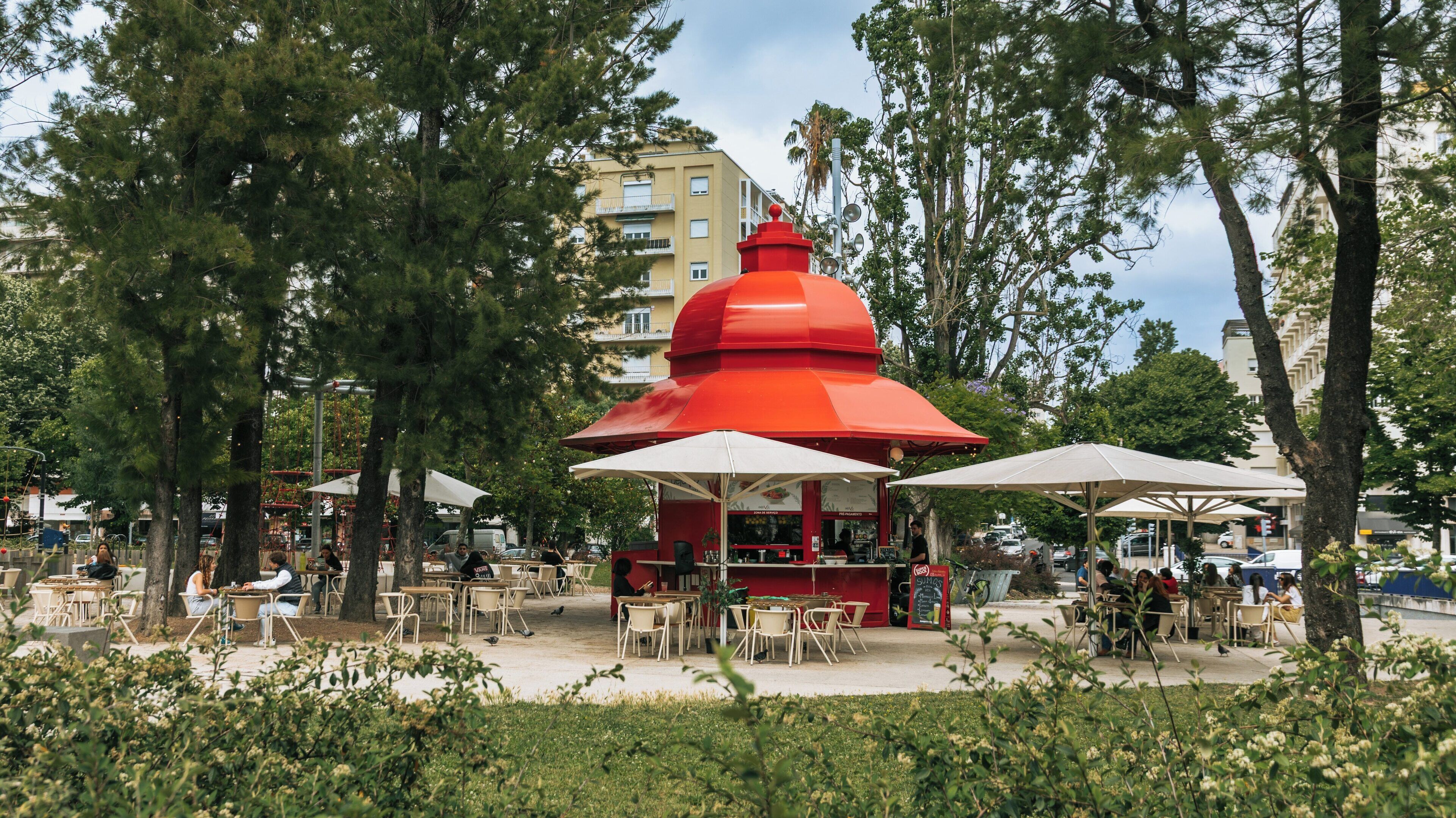 Exploring Campo Grande Park in Lisbon's City Center with vibrant kiosk and outdoor seating