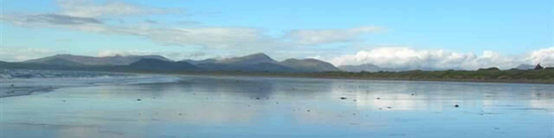 Wet beach at Harlech. With the beach reflecting just minutes after a huge thunderstorm. Looking north across to Porthmadog.