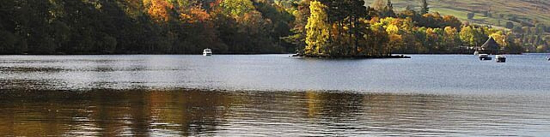 Loch Tay at Kenmore The small island is one of several Crannogs in the loch. The building on the right with the conical roof is the Scottish Crannog Centre: See http://www.crannog.co.uk/
