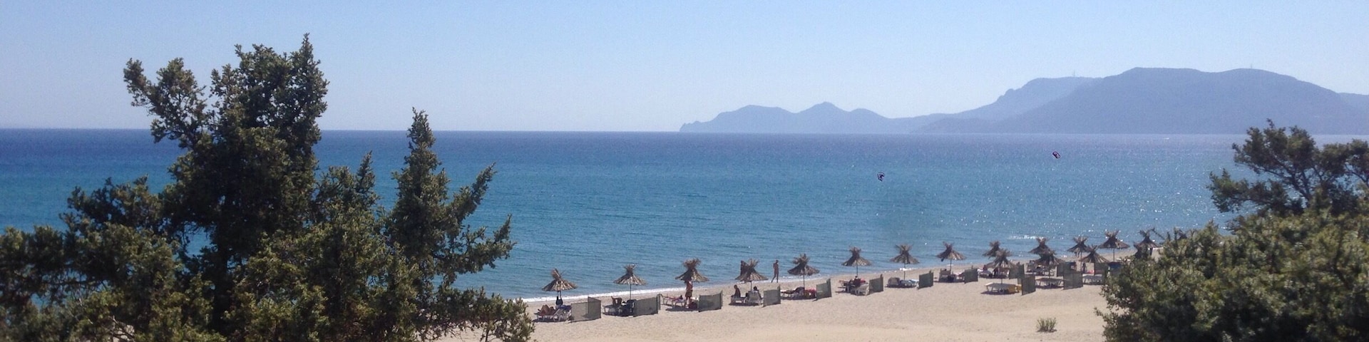 Exotic beach , paradise for nudists . Cedar trees , sand dunes , crystal clear water . Kos , Greece