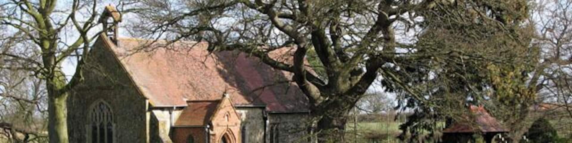 St Andrew's church in Thelveton This view was taken from Boudica's Way. Boudica's Way leads past the churchyard of St Andrew's church in Thelveton: coming from Norwich Road it crosses Church Road, passing the Grange and following Burston Road westwards until it turns off, leading across fields, to Frenze Hall, and to Diss from there. Boudica's Way is a 40-mile footpath that links Norwich and the market town of Diss on the Suffolk borders. The name Boudica (often spelled 'Boadicea', which was the Victorian version or 'Boudicca', used by Tacitus) derives from the Celtic 'bouda' which means victory. Boudica was the wife of the Icenian king Prasutagus. When he died his kingdom was annexed by the Romans, Boudica was flogged and her daughters raped. In AD 60 or 61 Boudica led the Iceni, along with others, in revolt. They destroyed Camulodunum (Colchester) and the site of a temple to the former emperor Claudius. Boudica was defeated in the end and is reported by Tacitus to have poisoned herself. The site where she is buried is unknown. St Andrew's church > https://www.geograph.org.uk/photo/1764785 is situated at a picturesque spot of the Thelveton Estate, bordered by fields and a cattle pasture. Boudica's Way long distance footpath > https://www.geograph.org.uk/photo/1764759 leads past the churchyard. The building - an estate church rather than a parish church - is of Norman origins but has been extensively restored by the Mann family, Lords of the Manor, from the late 1800s onwards. The tower collapsed in 1757 and has not been replaced, the furnishings date from the C19 restoration and the marble reredos > https://www.geograph.org.uk/photo/1764847 with mosaic inlay dates from that time. The chancel also houses a wall memorial to Thomas Mann (1886) > https://www.geograph.org.uk/photo/1764859 which was made by C Stoatt. The Mann family owns the estate to this day. The east window > https://www.geograph.org.uk/photo/1764855 was presented in 1899 in memory of Thomas Mann and his wife. The stained glass windows > https://www.geograph.org.uk/photo/1764864 are of very good quality, unfortunately noboby could tell me who made them. The octagonal font > https://www.geograph.org.uk/photo/1764872 is C15 and a large royal arms for Charles I (1620s) > https://www.geograph.org.uk/photo/1764874 hangs above the south doorway.