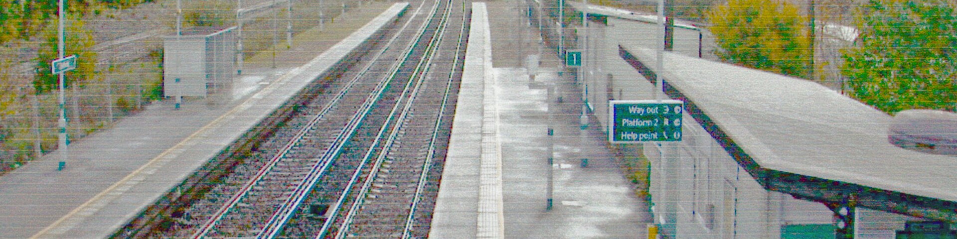 Salfords station, 2004. View southwards, towards Gatwick, Brighton etc.: ex-LB&SCR London - Brighton etc. main line. The station has platforms on the Slow lines only, which run through Redhill. It was opened in 1915 as an unadvertised Halt for local factories and only opened to the public in 1932, the suffix 'Halt' being dropped in 1935.