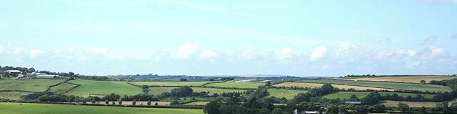 High Bickington: towards Lower Chapple Lower Chapple stands on the site of St Johns Chapel, within the square and by the Atherington Torrington road. It can be seen on the horizon on the extreme left. Looking north-north-west