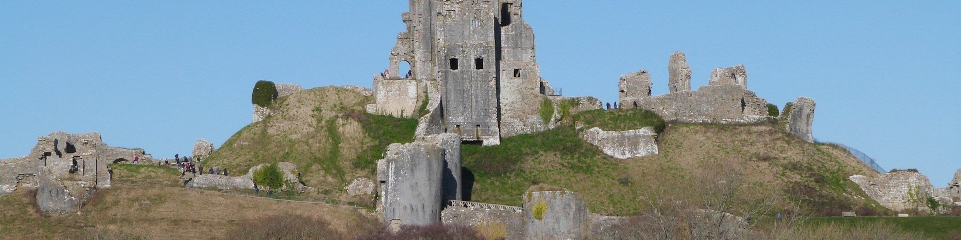 Corfe Castle is a fortification standing above the village of the same name in the English county of Dorset. Built by William the Conqueror, the castle dates back to the 11th century and commands a gap in the Purbeck Hills on the route between Wareham and Swanage.