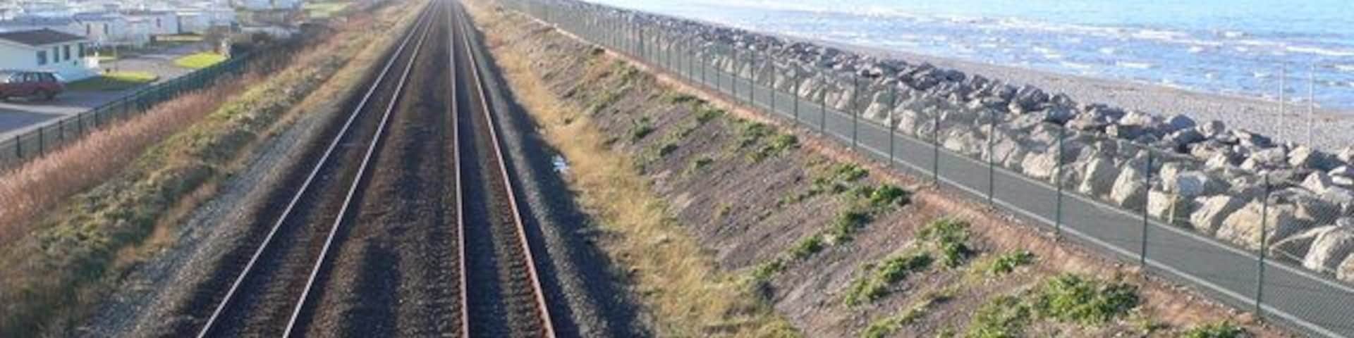 The railway to Holyhead The main line from London to Ireland, between the caravan parks and the sea.