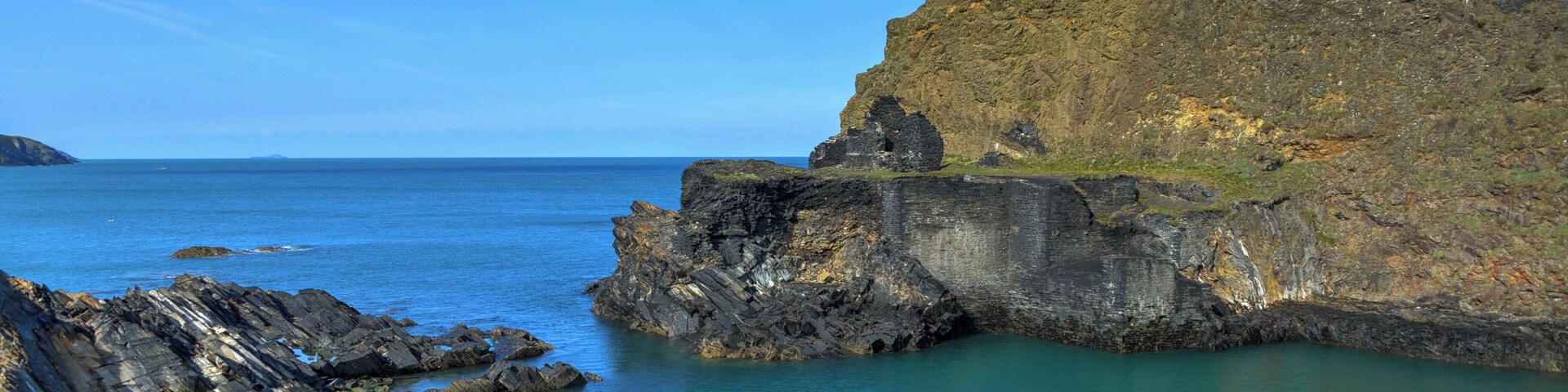 The Blue Lagoon, an old slate quarry now inundated by sea water. The lagoon water is colored differently from the sea water due to the minerals in the old quarry.