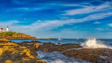 Um farol sobre um afloramento rochoso, com o oceano ao fundo.