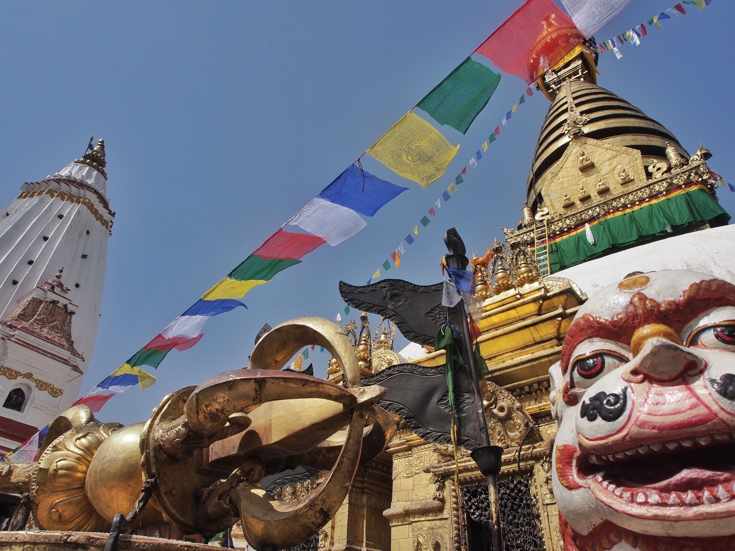 Swayambhunath is an ancient religious complex atop a hill in the Kathmandu Valley, west of Kathmandu city, Nepal. It is also known as the Monkey Temple as there are holy monkeys living in the north-west parts of the temple, it occupies a central position and it is probably the most sacred among Buddhist pilgrimage sites. For Tibetans and followers of Tibetan Buddhism, it is second only to Boudhanath. 
I was lucky enough to visit Nepal, see it and take some pictures a week before the 2015 earthquake. The temple complex suffered damage in  the Nepal earthquake. :-(