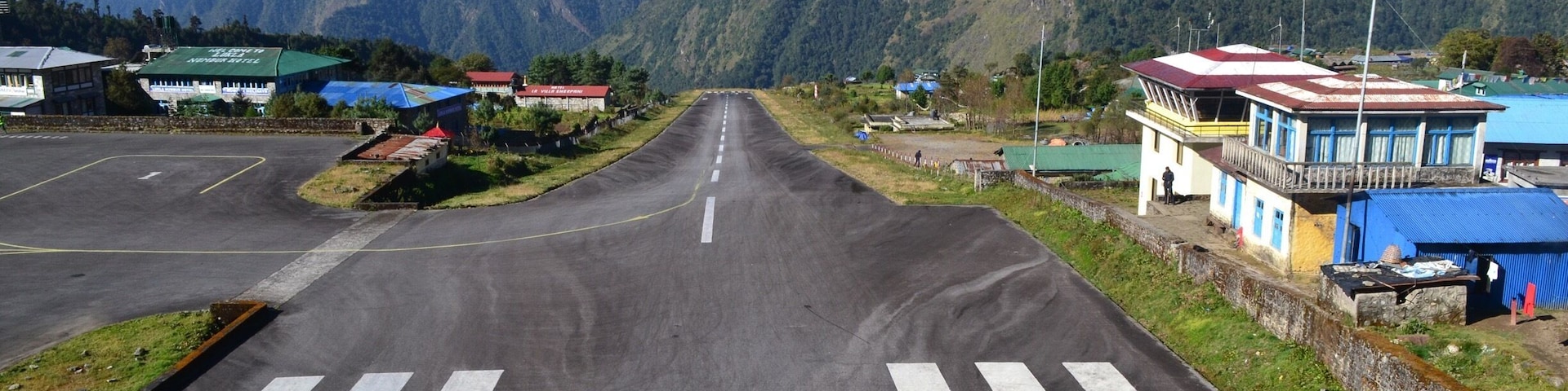 Lukla Airport one of most dangerous air strips in the world. Only 460 meters in length with a 50 meter elevation change from the bottom of the runway to the top and about a 9000 ft drop off at the end of the runway.