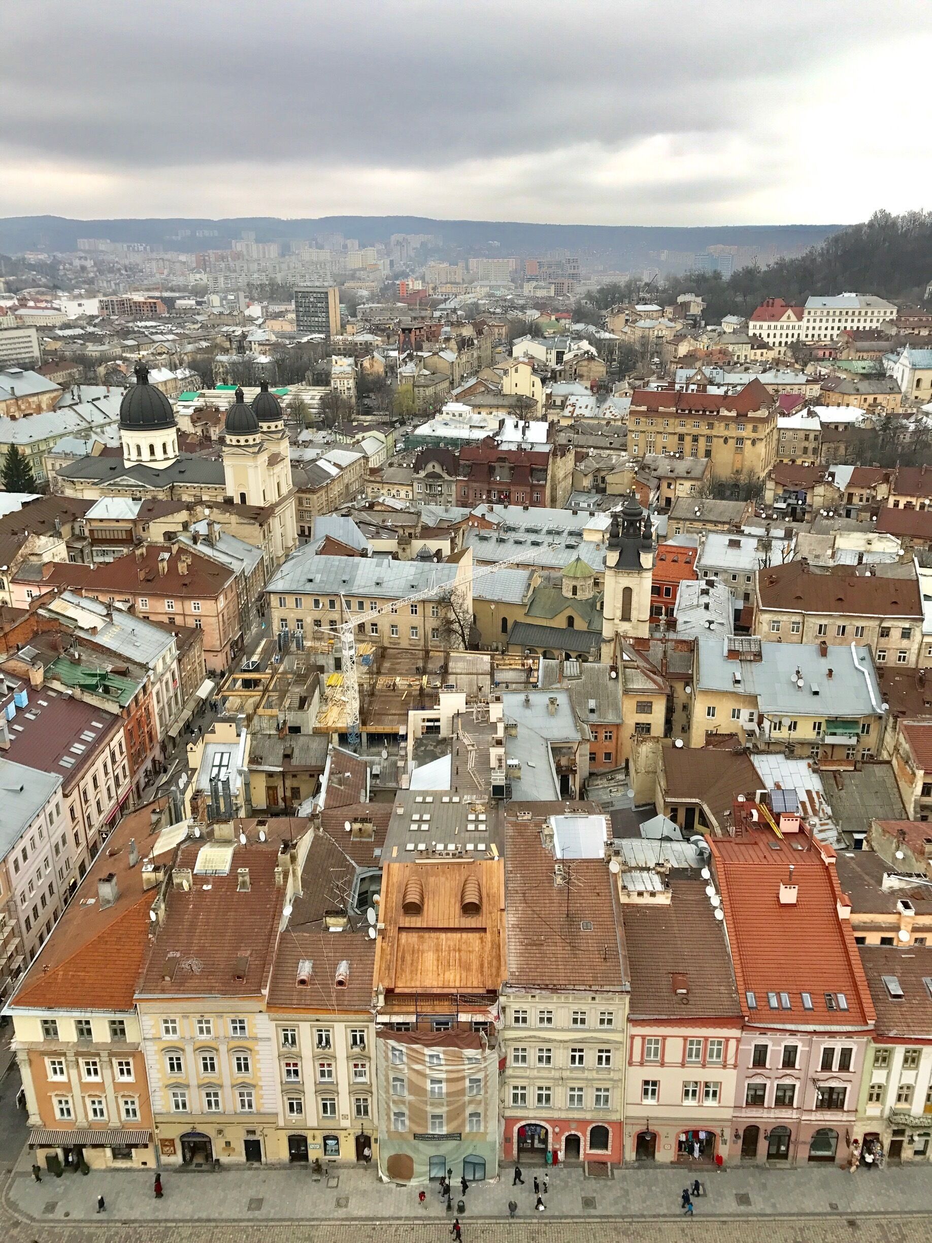Lviv, Ukraine. Very European and Russian. Pay a small fee and climb 409 stairs in the bell tower for this lovely view.