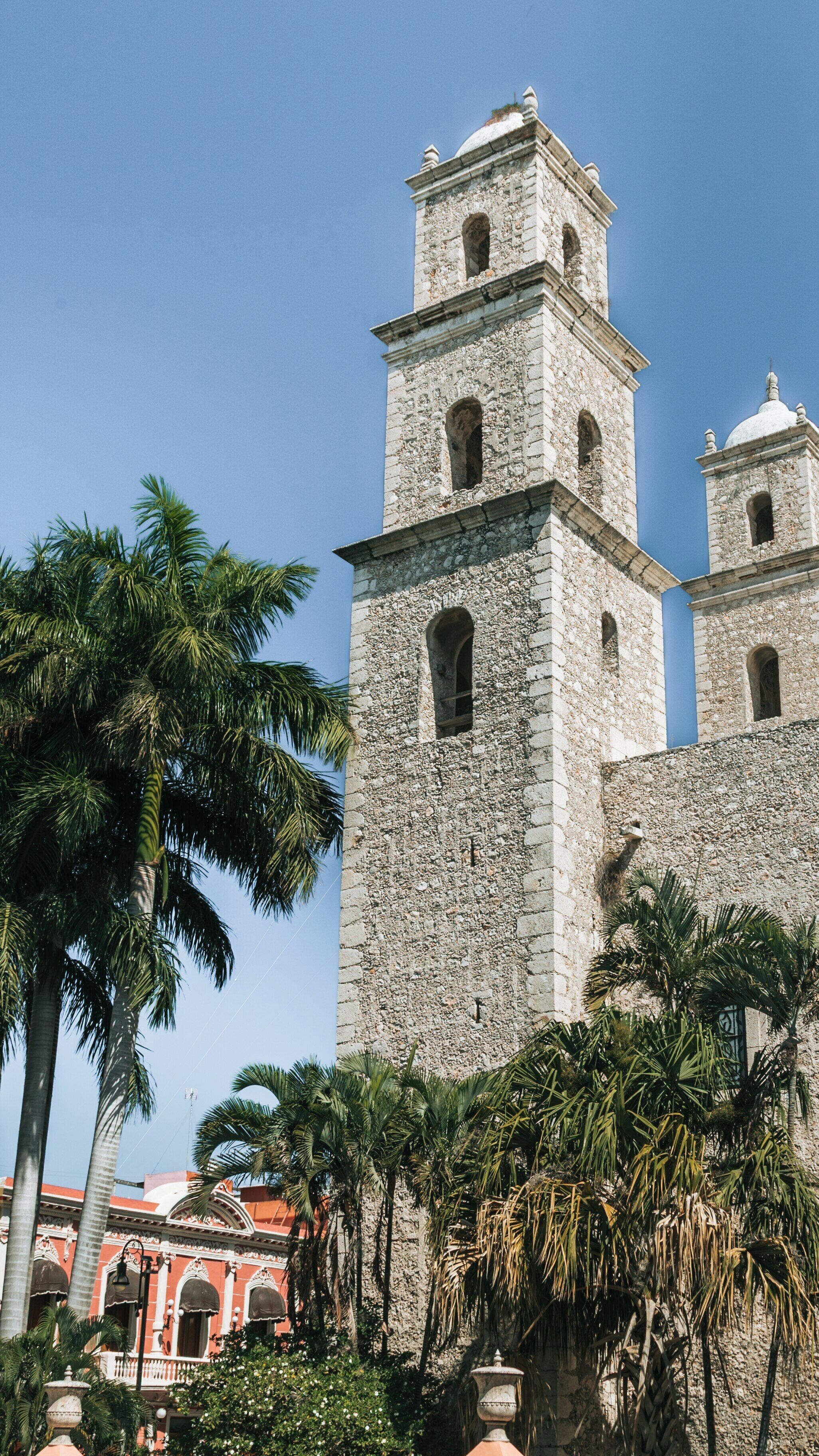 Exploring the historic architecture of Hidalgo Park in downtown Merida, Yucatan under clear blue skies