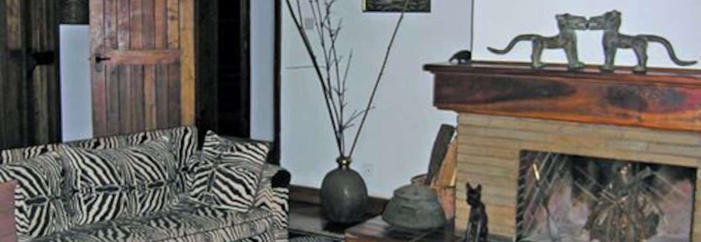 This charming B&B is in a suburb of Nairobi, within a 10 minute walk to the Giraffe Centre. 
The living room felt like Hemingway should be sitting on the couch.