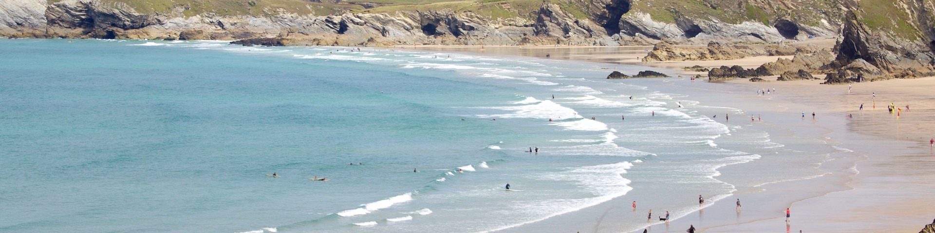 Newquay featuring landscape views and a beach as well as a large group of people