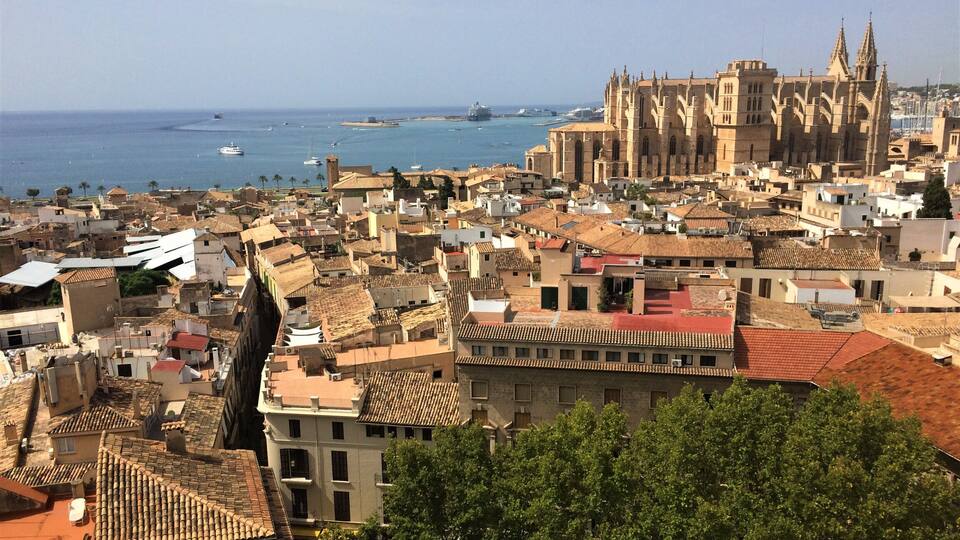 View from the Parròquia de Santa Eulàlia looking out over the old town of Palma, Mallorca. The Cathedral de Santa María is the beautiful gothic building in the distance.