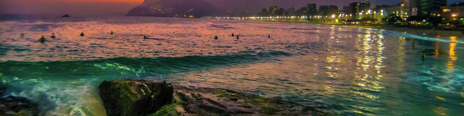 By far the best spot to watch the sunset at the beach (Sugarloaf mountain is THE best in Rio).
New York Times: “If you want to know why people come to Rio de Janeiro, and came even during its years of bloody, decadent decline, stand on the Arpoador Beach promenade at day’s end. Before you lies an orchestral finale of a sunset: iridescent water, pastel-streaked skies and hazy silhouettes of cliffs to the west. Behind you are swarms of Cariocas, as Rio natives are known: men with phones tucked into the fronts of their bathing suits, swimmers shaking off droplets of water before ordering caipirinhas at an outdoor bar. At the moment when the neon-pink sun slips below the horizon, everyone stops, stands and claps: a nightly salute to city, beach and sky.”