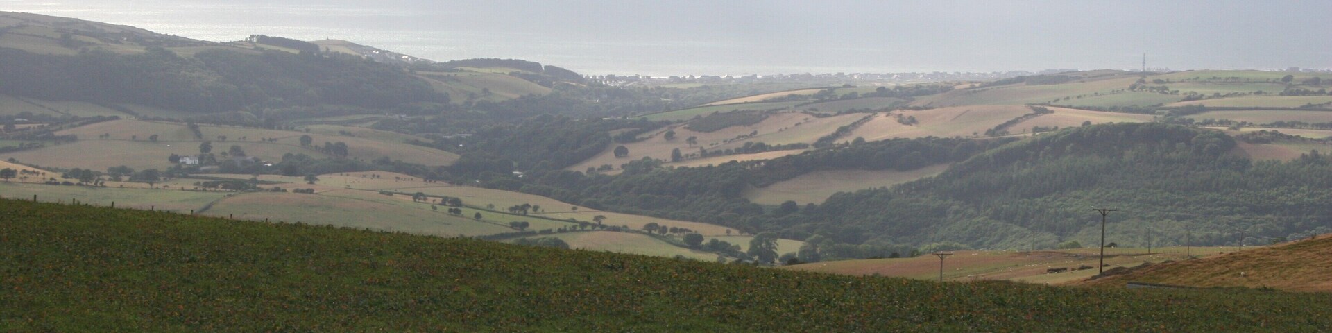 Looking for the way down There are so many many turbine related paths and wire fences around the Mynyddgorddu wind farm that trying to find a mere footpath can be difficult at times. Eventually I found my way back to the Leri Valley, seen here in the middle distance.