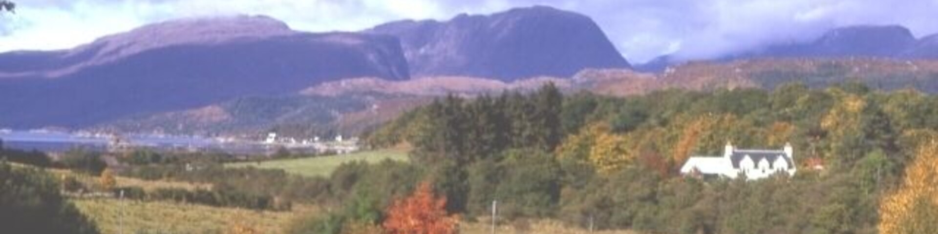 Fernaig. Beyond the autumn colours of the woods around Fernaig is the hamlet of Ardaneaskan on outer Loch Carron, with the mountains of Applecross in the distance.