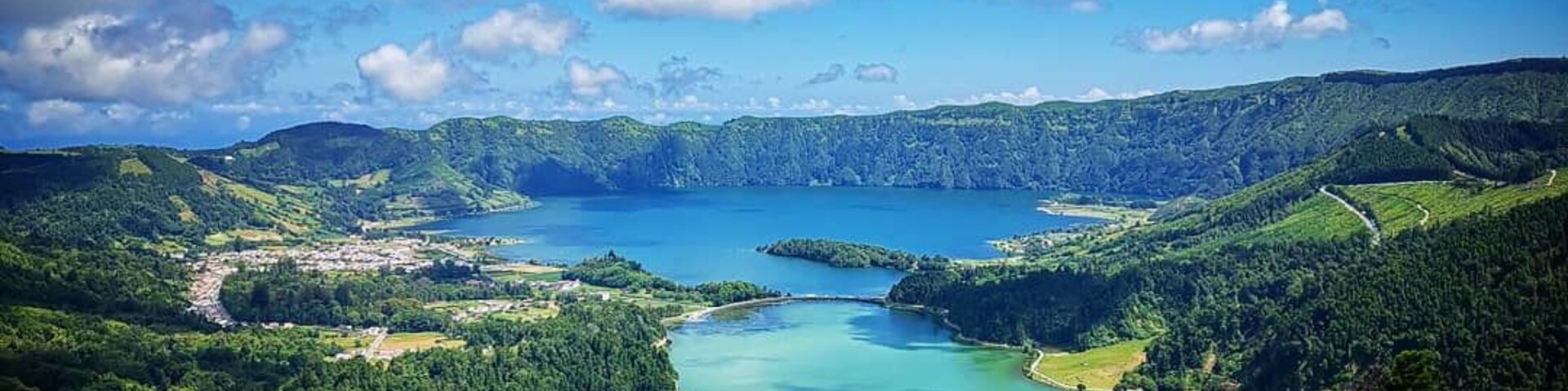 Lagoa das Sete Cidades is a twin lake situated in the crater of a dormant volcano on the Portuguese archipelago of the Azores. It consists of two small, ecologically different lakes connected by a narrow strait, which is crossed by a bridge. The volcano is located on the western third of the island of São Miguel.
