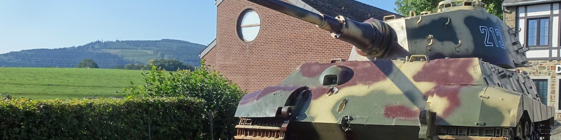 A tank for a bottle of cognac?
This German “Königstiger II” was abandoned in the Belgian Ardennes during the Battle of the Bulge (that started 75 years ago, in December 1944). Normally he would have been taken to be scrapped shortly after the war, but a woman from the village La Gleize (Jenny Geenen-Dewez, wife of a local inn-keeper) proposed the Americans who transported the Königstiger, to exchange the tank for a bottle of (French) cognac and ... they agreed! Believe it or not, this is a true story! 
In 2015 the tank was repainted in its original colours. He is one of the 5 surviving tanks of this type in Europe.
http://www.december44.com/en/history_battle_of_the_bulgela_gleize.htm
#LocalSecrets  #History
The Königstiger II had 185 mm armour on the front of the cupola and was equipped with the famous 88 mm cannon. This cannon was one of the strongest cannons from WW II and could pierce the front armour of most Allied tanks (such as the T-34 and the M4 Sherman) up to a distance of 1500 metres. The range of the cannon was 10 kilometres.