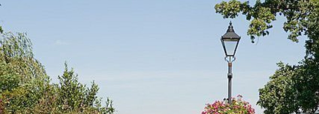 Path through Grove Gardens, Hythe. These gardens are behind The Grove which is a local government building. 514712 can be seen in front of Southampton Water.