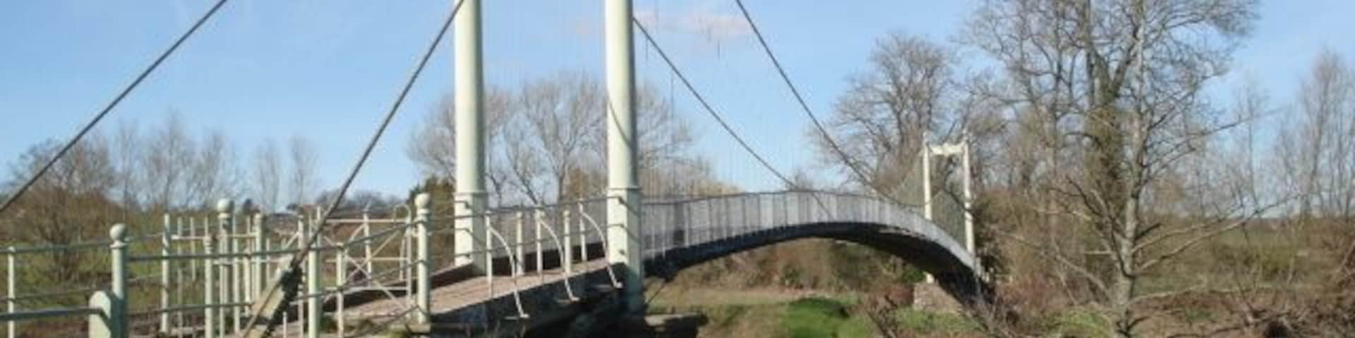 Suspension Footbridge over the River Wye This bridge was designed and built by Louis Harper in 1895 at the request of local folk who wanted their vicar to be able to move easily between his two churches at Sellack and Kings Caple. The Harper Bridges web site has excellent information on the many bridges they constructed around the country and the fence post patent which led to the success of the company. There is still evidence of at least one more bridge to be found over the Derwent - a job for Geograph-ers? http://www.harperbridges.com