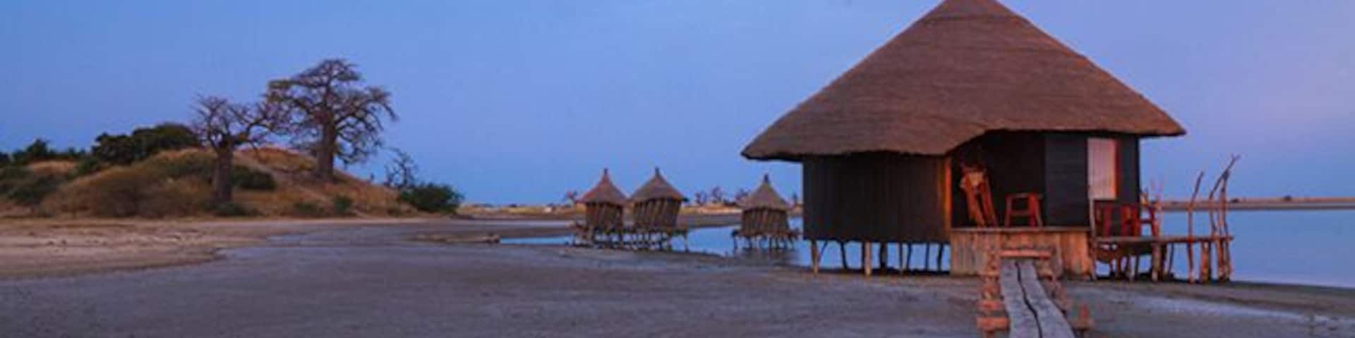 Lodge de Niassam is a eco lodge in paradise! You can live in 3 different cabins; hut on stilts in the lagune, a tree hut in a Baobab tree or a beautiful cabin on the ground. 
Read more on: http://www.travelwithallsenses.com/lodge-de-niassam-eco-lodge-paradise/