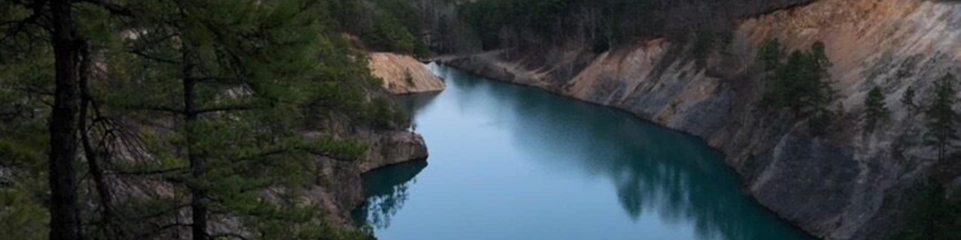 Might have to do a bit of hiking to get to this spot but it's worth it. Use to be a quarry and kids would throw all kinds of stuff down there