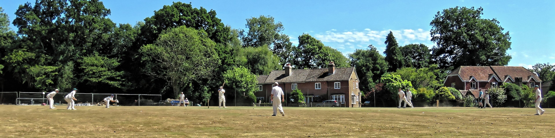 A public friendly Sunday cricket match between Nuthurst Cricket Club (batting), representing Nuthurst parish, and Henfield Cricket Club representing Henfield parish, on the village green cricket ground at Mannings Heath in West Sussex, England. Camera: Canon PowerShot SX60 HS Software: File lens-corrected, optimized, perhaps cropped, with DxO PhotoLab , and likely further optimized with Adobe Photoshop CS2.