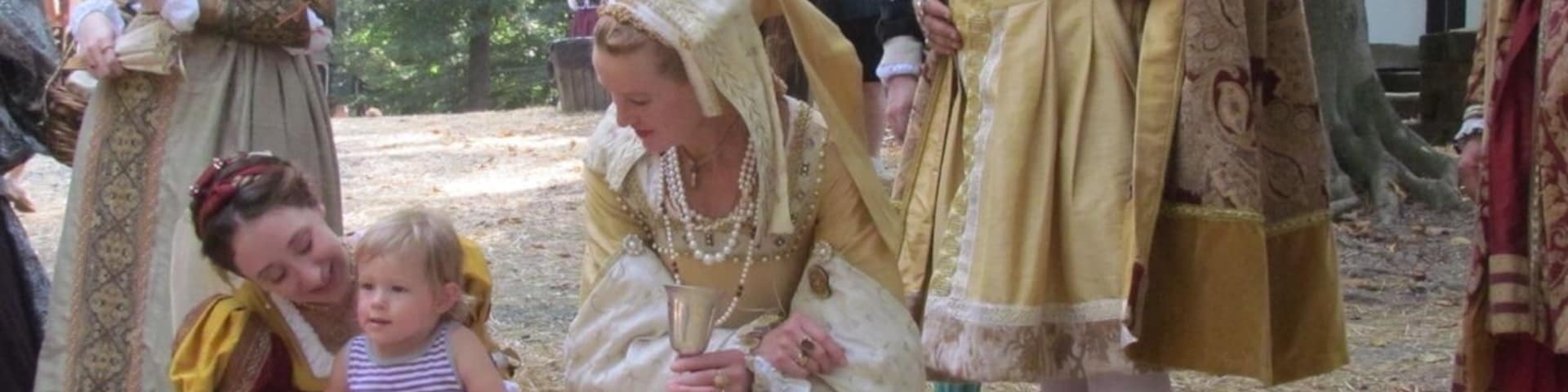 Their Majesties greeting a young visitor.